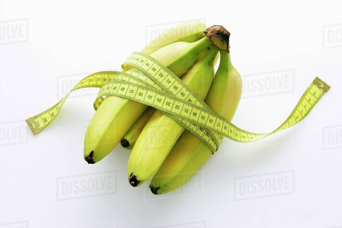 Bunch of bananas with a tape measure - Royalty-free Stock Photo | Dissolve