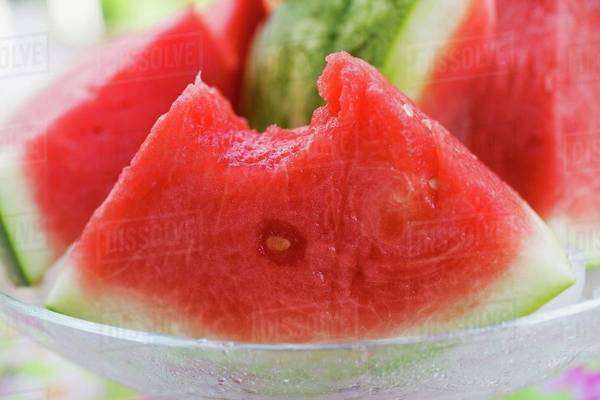 Wedge of watermelon, a bite taken, in a glass bowl - Royalty-free Stock ...