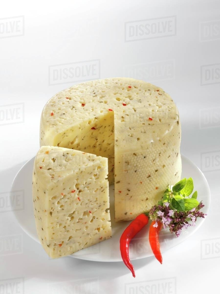 Tilsiter cheese with herbs and chilli - Stock Photo - Dissolve