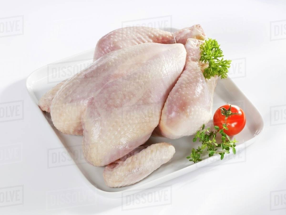 Fresh chicken on a serving plate - Royalty-free Stock Photo | Dissolve