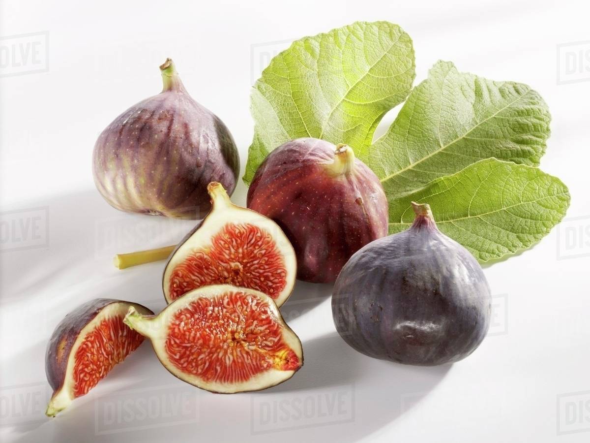 Three whole figs and one cut into pieces - Royalty-free Stock Photo ...