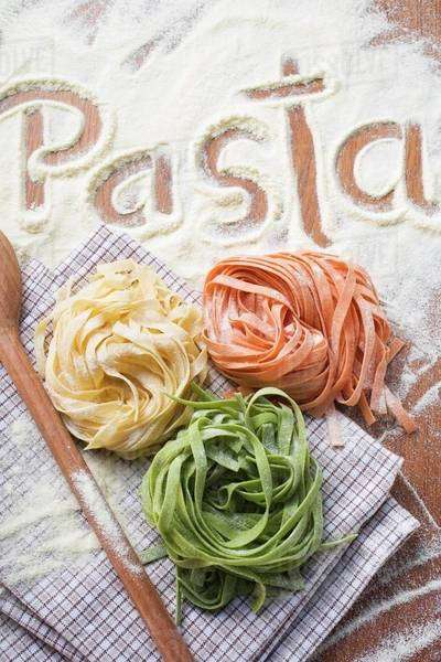 Ribbon pasta in three colours - Royalty-free Stock Photo | Dissolve