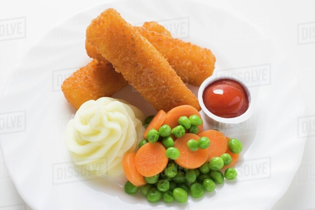 Fish fingers with mashed potato, peas and carrots - Stock Photo - Dissolve