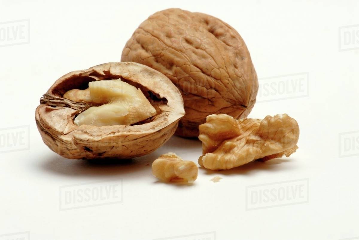 Unshelled walnut and half walnut with kernel - Royalty-free Stock Photo ...