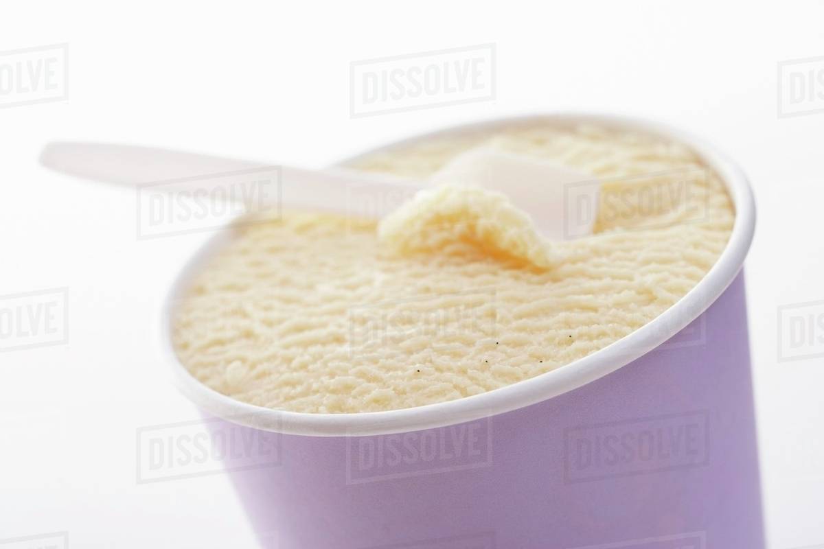 Vanilla ice cream in cardboard tub with plastic spoon - Royalty-free ...