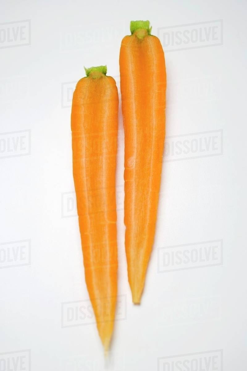 Peeled carrot, halved - Stock Photo - Dissolve