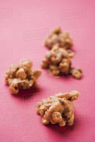 Nut sweets on pink background - Royalty-free Stock Photo | Dissolve