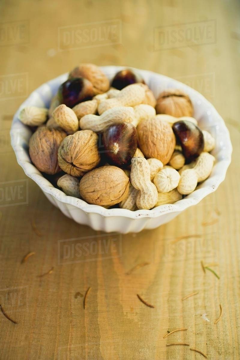 Walnuts, chestnuts and peanuts in white bowl - Royalty-free Stock Photo ...