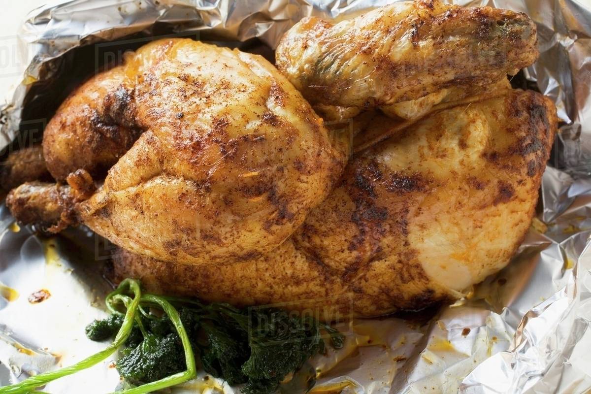 Half a roast chicken in aluminium foil - Royalty-free Stock Photo ...
