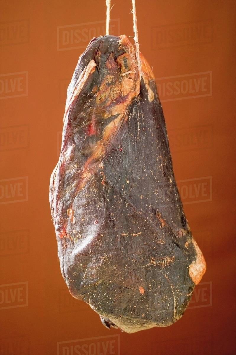 Smoked venison ham (hanging up) - Royalty-free Stock Photo | Dissolve