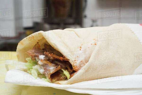Doner wrap on paper napkin in snack bar - Royalty-free Stock Photo ...