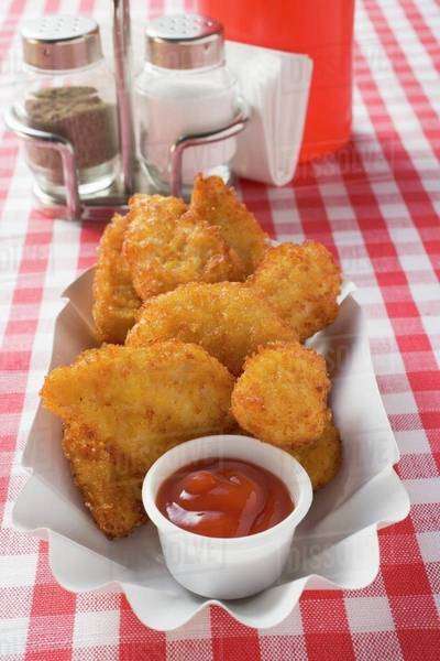 Chicken nuggets with ketchup in paper dish in snack bar - Stock Photo ...