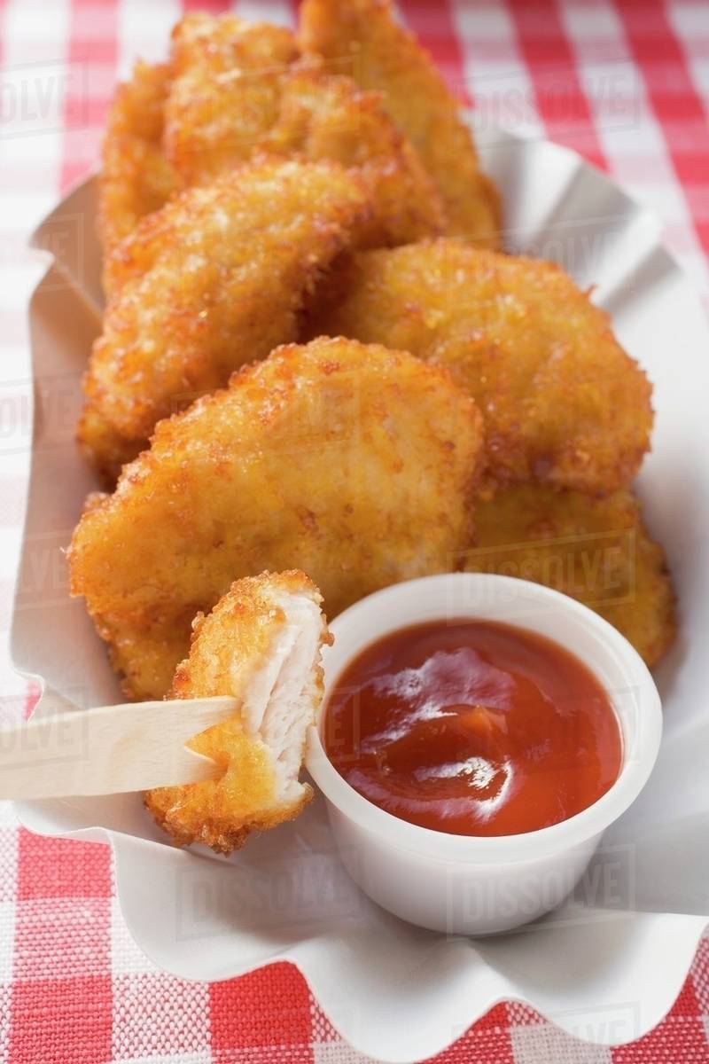 Chicken nuggets with ketchup in paper dish - Royalty-free Stock Photo ...