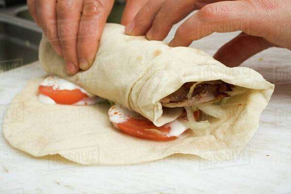 Making a doner wrap (rolling up) - Royalty-free Stock Photo | Dissolve