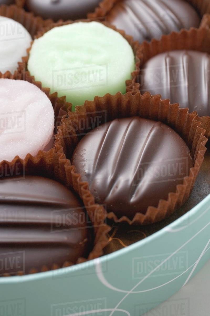 Assorted chocolates in round box (detail) - Stock Photo - Dissolve