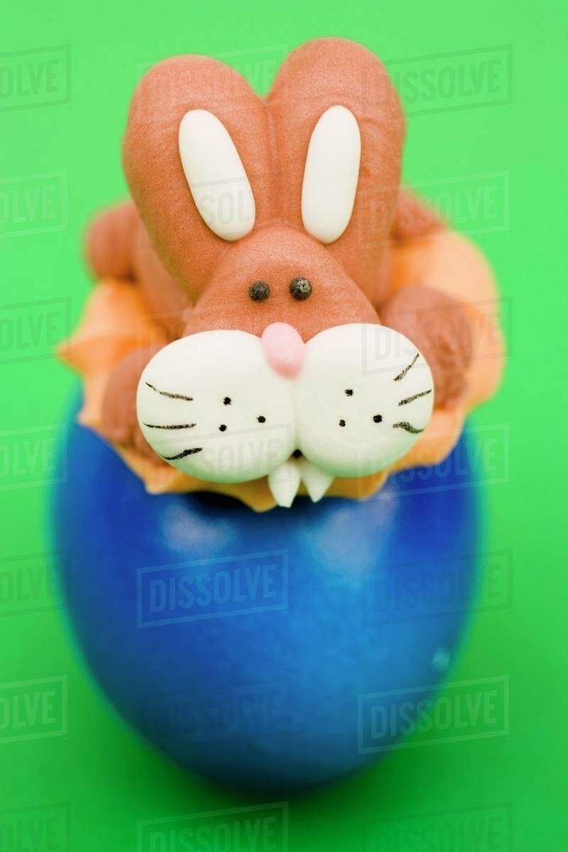 Marzipan Easter Bunny on blue egg - Royalty-free Stock Photo | Dissolve
