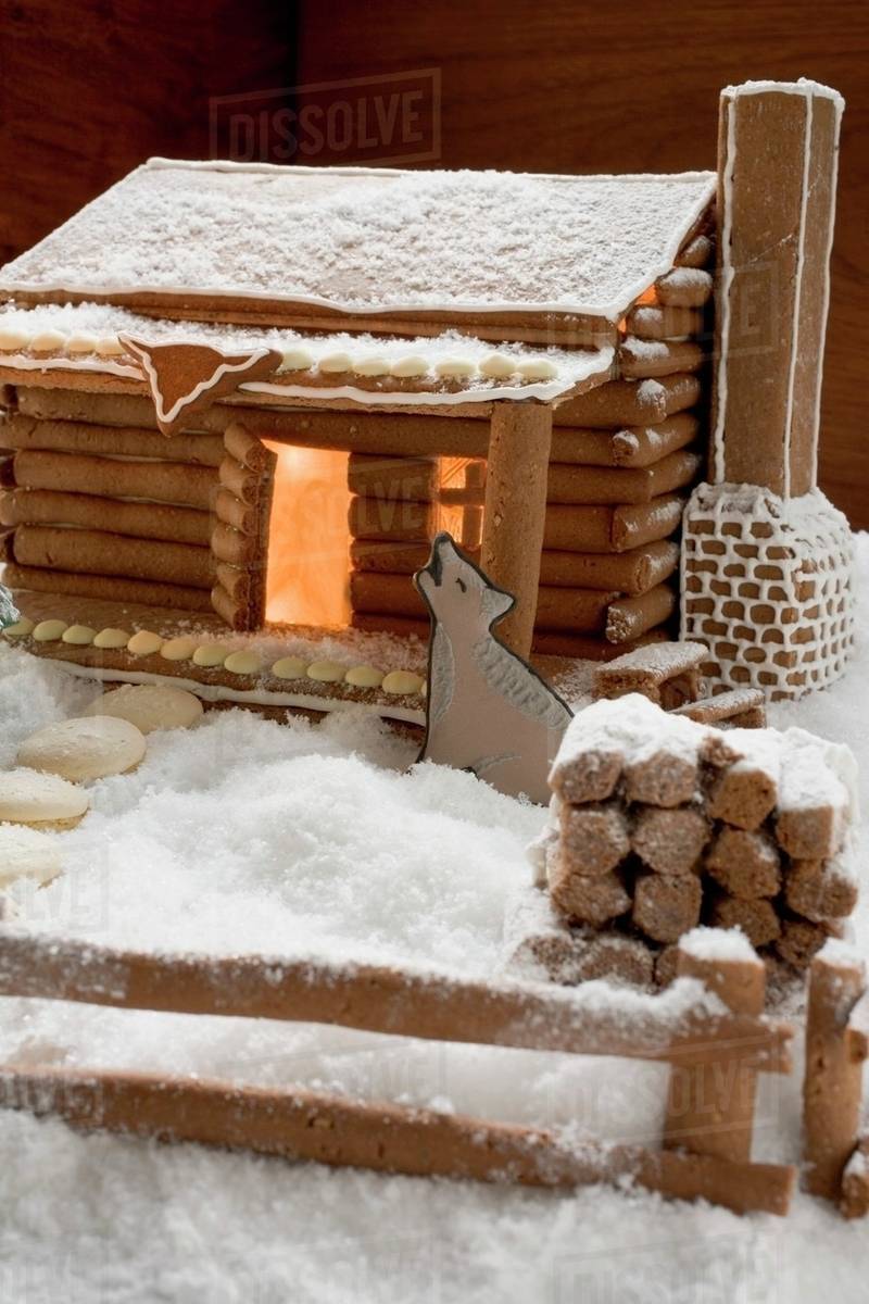 Gingerbread house with gingerbread animal - Stock Photo - Dissolve