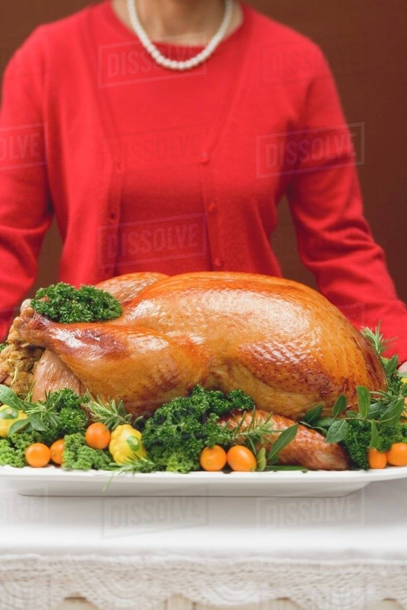 Woman holding roast turkey on large platter - Royalty-free Stock Photo ...
