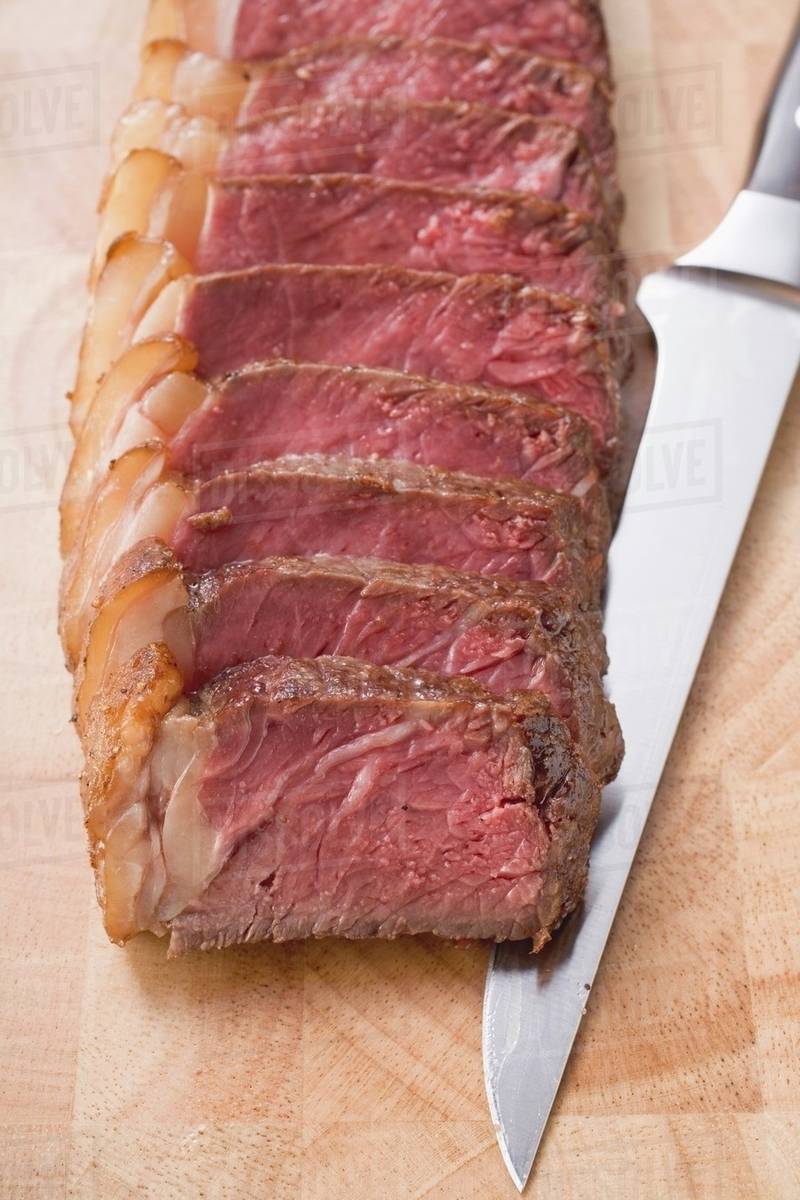 Beef steak with fatty edge, sliced - Royalty-free Stock Photo | Dissolve