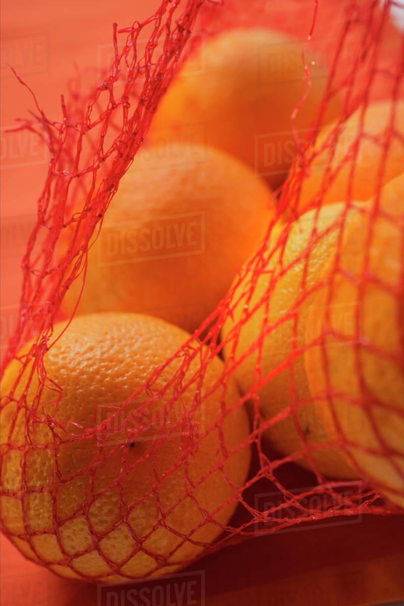 Oranges in net - Stock Photo - Dissolve