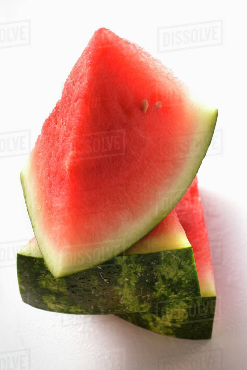 Three watermelon wedges in a pile - Stock Photo - Dissolve