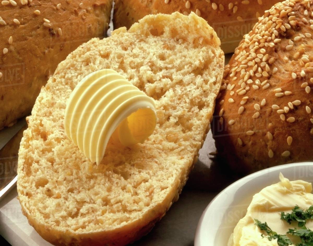 Half a bread roll with butter - Royalty-free Stock Photo | Dissolve