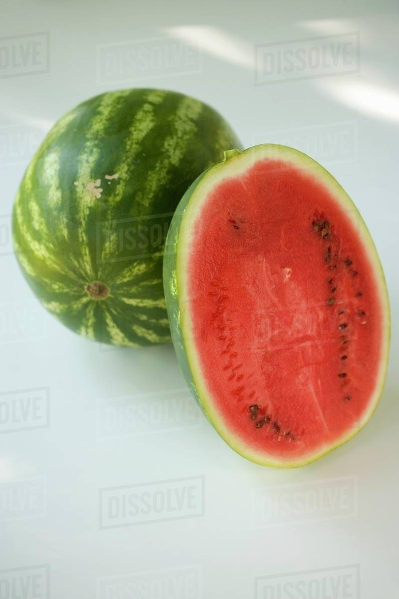 One half and one whole watermelon - Royalty-free Stock Photo | Dissolve