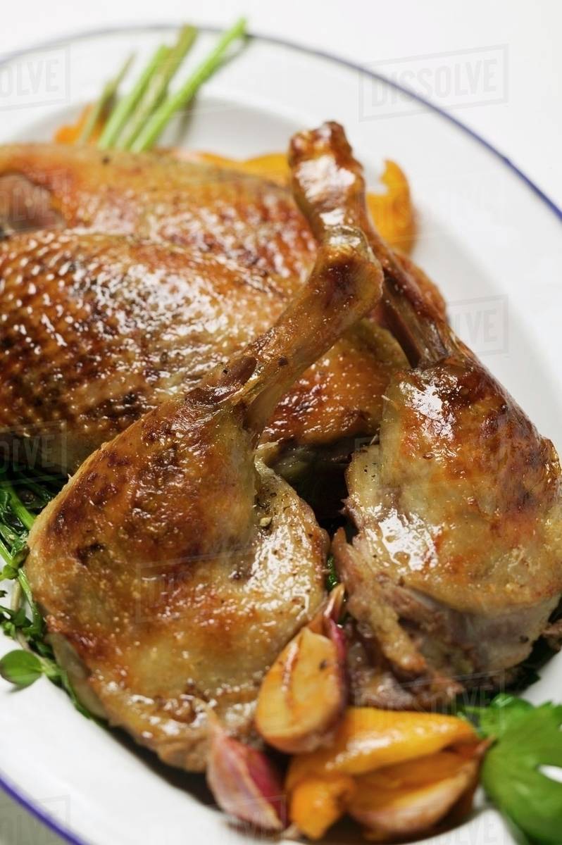 Roast goose pieces with garlic - Royalty-free Stock Photo | Dissolve