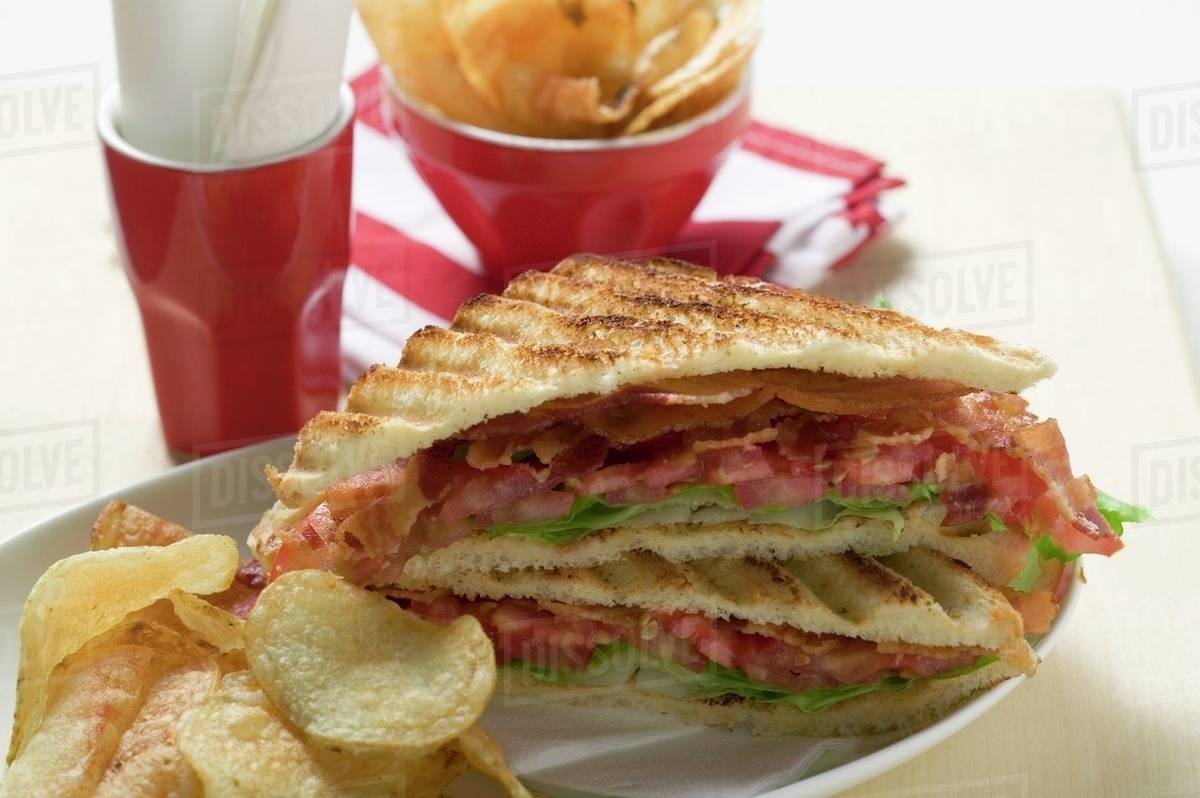 BLT sandwiches, toasted, with crisps - Royalty-free Stock Photo | Dissolve