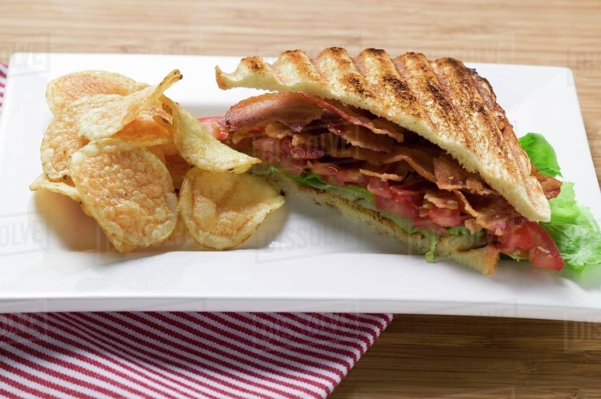 BLT sandwich, toasted, with crisps - Royalty-free Stock Photo | Dissolve