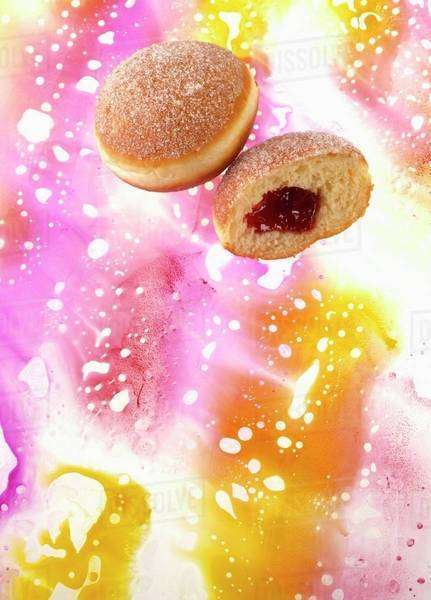 One whole doughnut and one cut open - Royalty-free Stock Photo | Dissolve