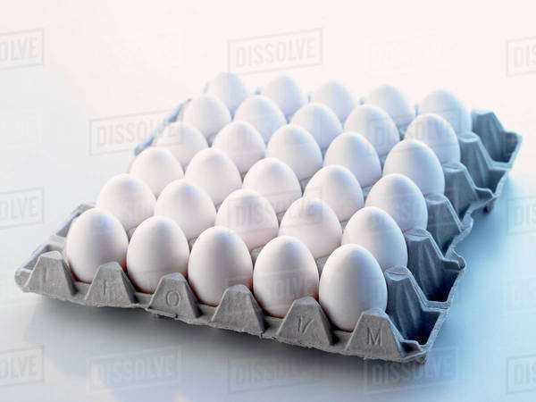 White eggs in an egg tray - Stock Photo - Dissolve
