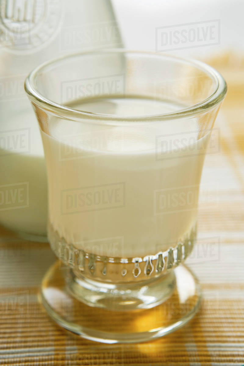 Glass of milk in front of carafe of milk - Royalty-free Stock Photo ...
