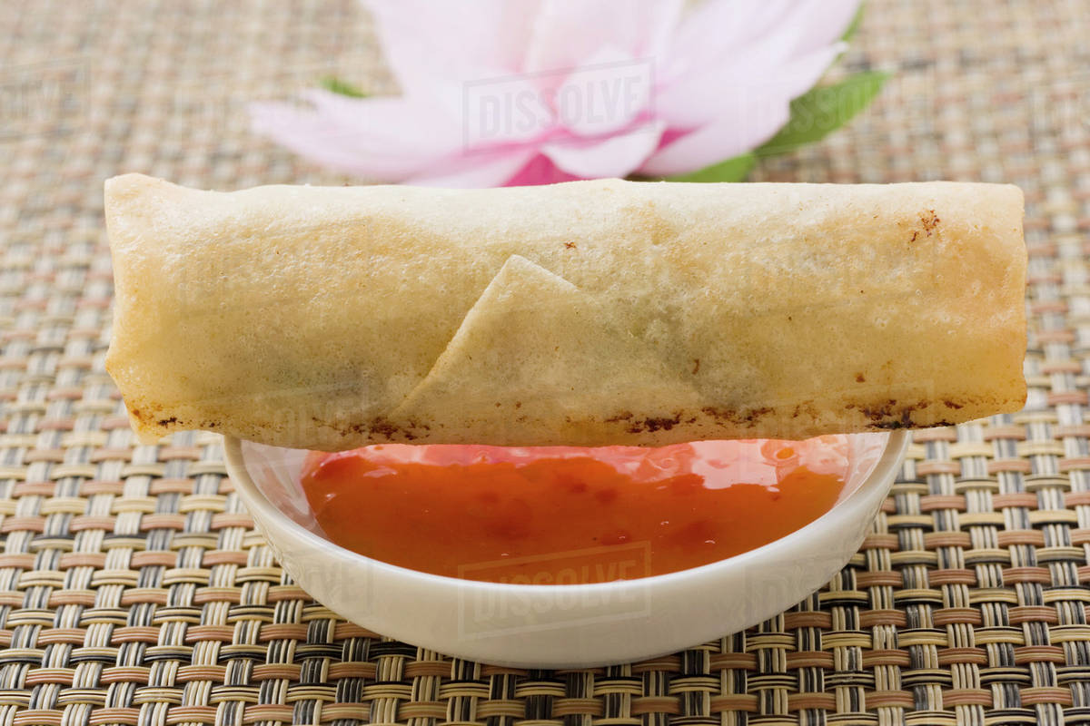 Spring roll on chili dip - Royalty-free Stock Photo | Dissolve