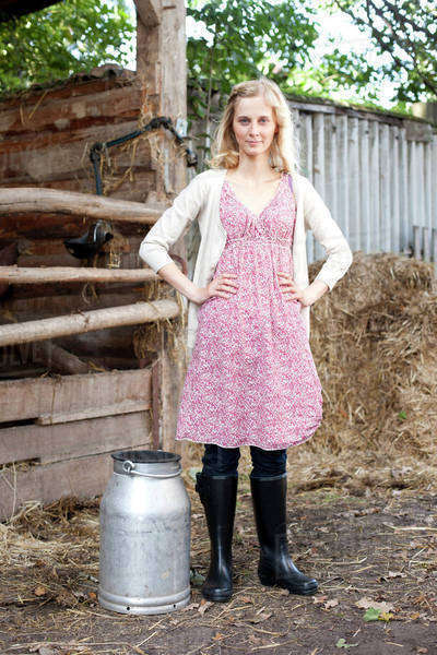 Germany, Saxony, Young woman with milk churn, portrait - Stock Photo ...