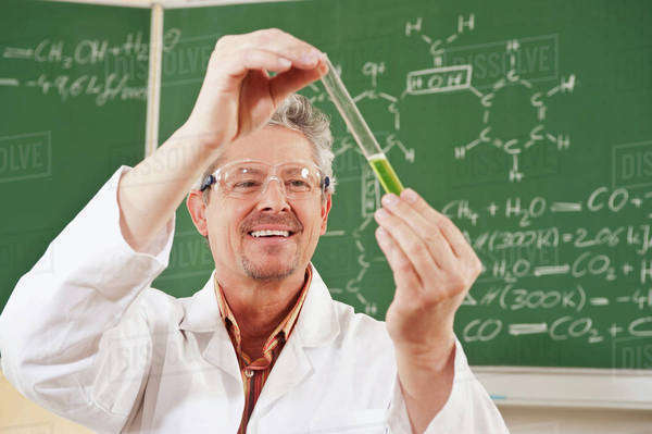 Germany, Emmering, Mature man doing experiment, smiling - Stock Photo ...