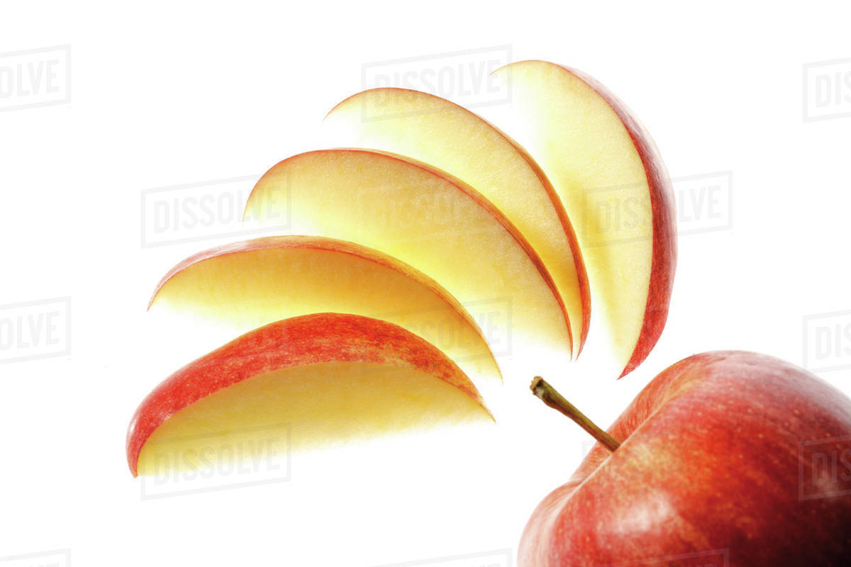 Sliced apple and whole fruit, close-up - Stock Photo - Dissolve