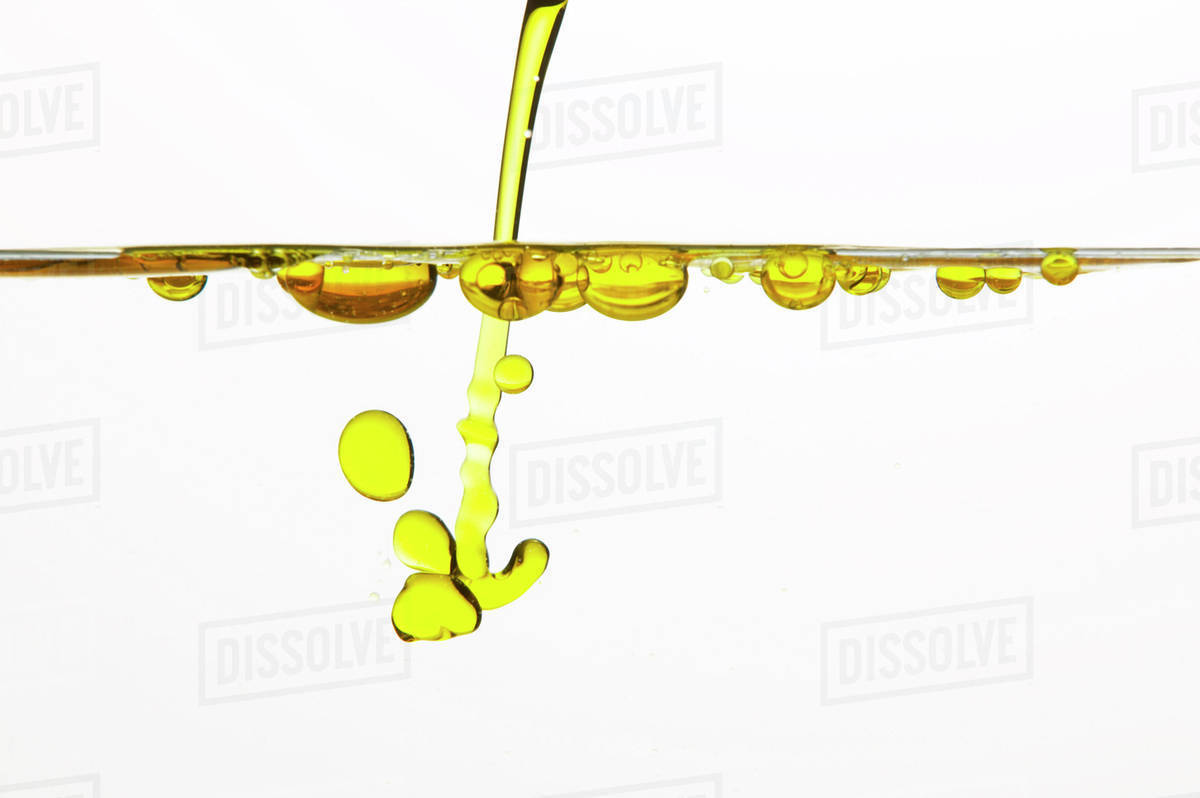Oil drops in water, close-up - Stock Photo - Dissolve