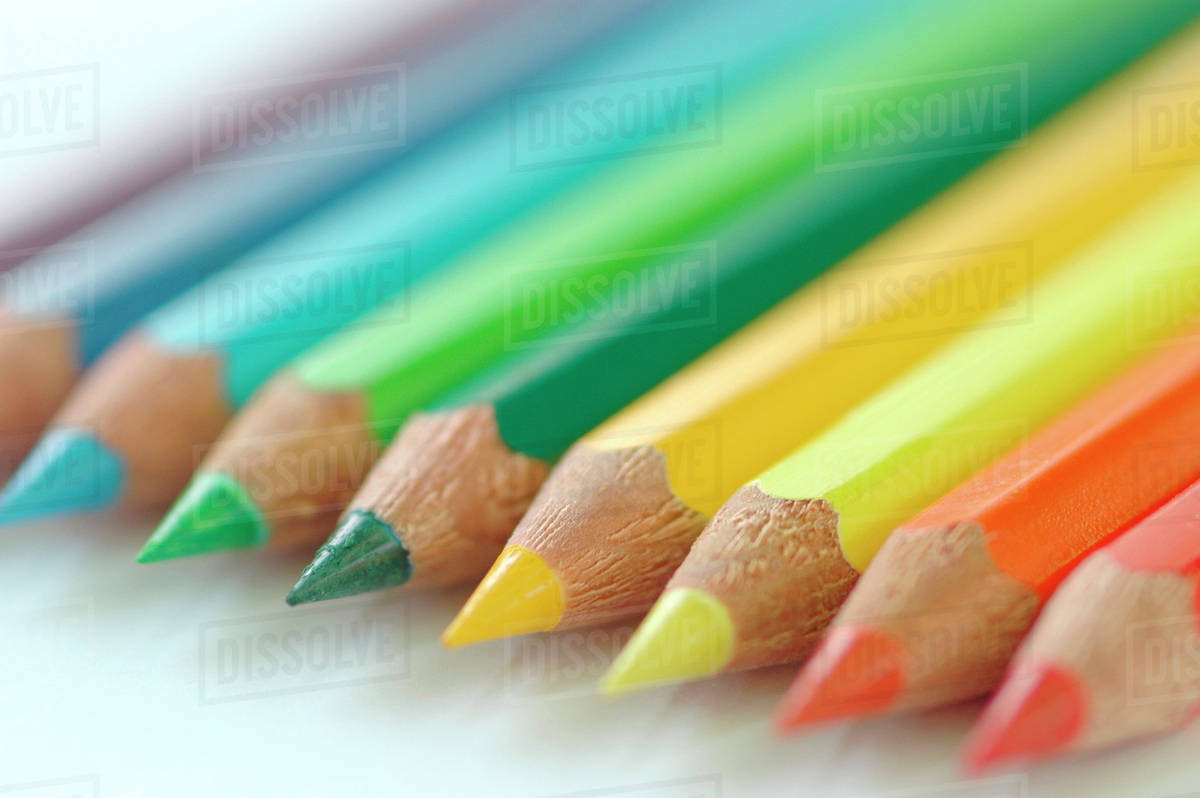 Row of colored pencils with sharp points - Stock Photo - Dissolve