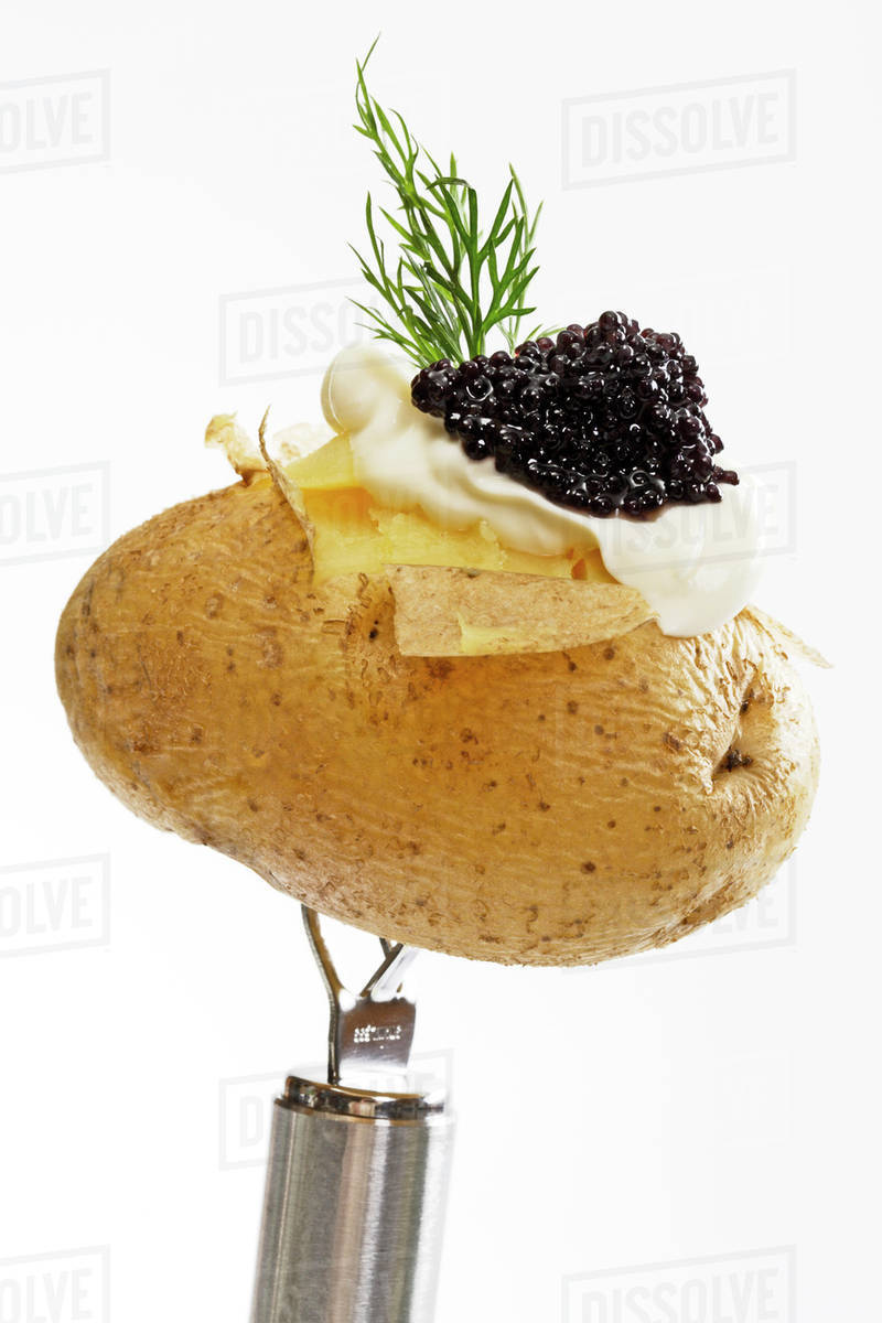 Potato with caviar, close-up - Stock Photo - Dissolve