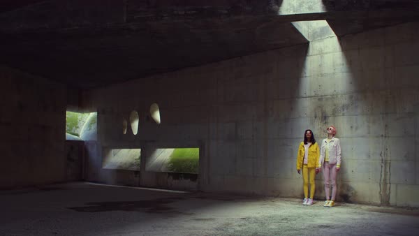 Two fashionable women standing inside of an abandoned building - Stock ...