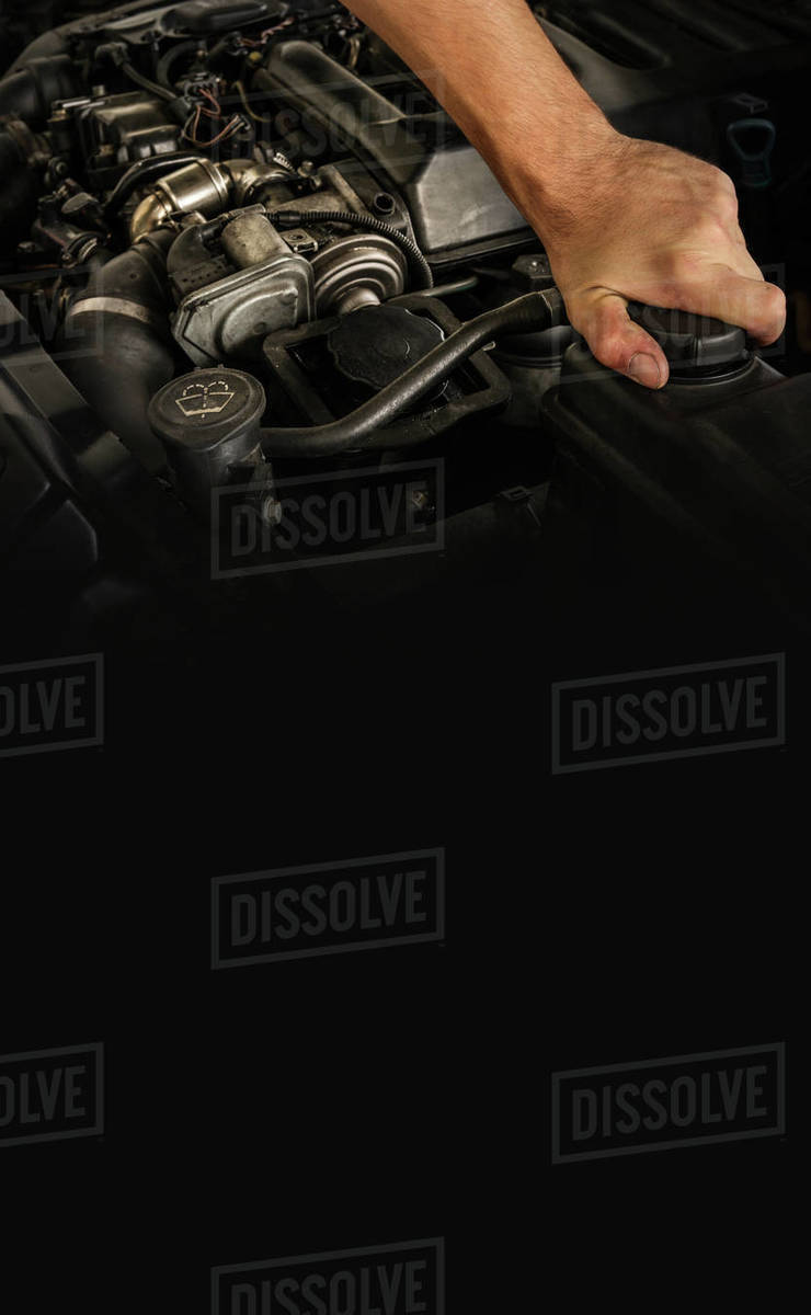 Auto mechanic working on car engine in mechanics garage. Repair service ...