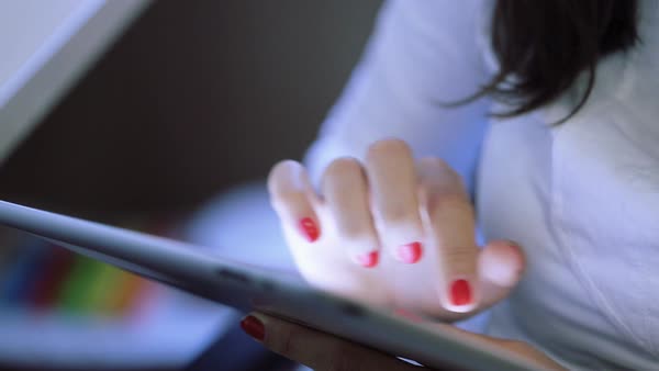 Close up to view young woman's hands hold black tablet with empty ...