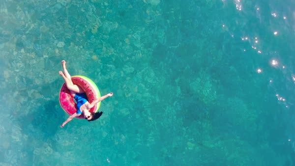 Girl floats in a pool on a rubber ring. - 4K Royalty-free Stock Video ...