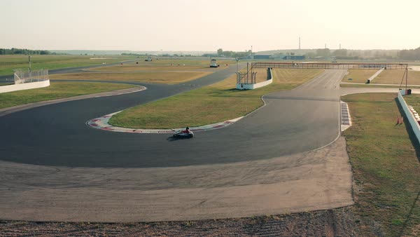 Outside view of a track with a racing car riding through it - 4K ...