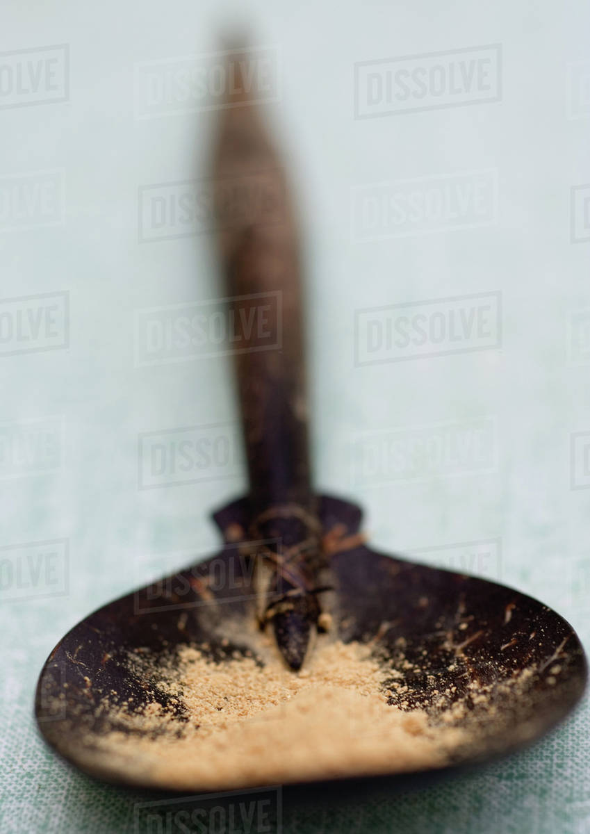 Ginger powder in wooden spoon - Stock Photo - Dissolve