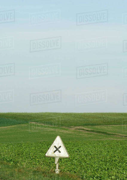 Warning sign and field of crops - Royalty-free Stock Photo | Dissolve