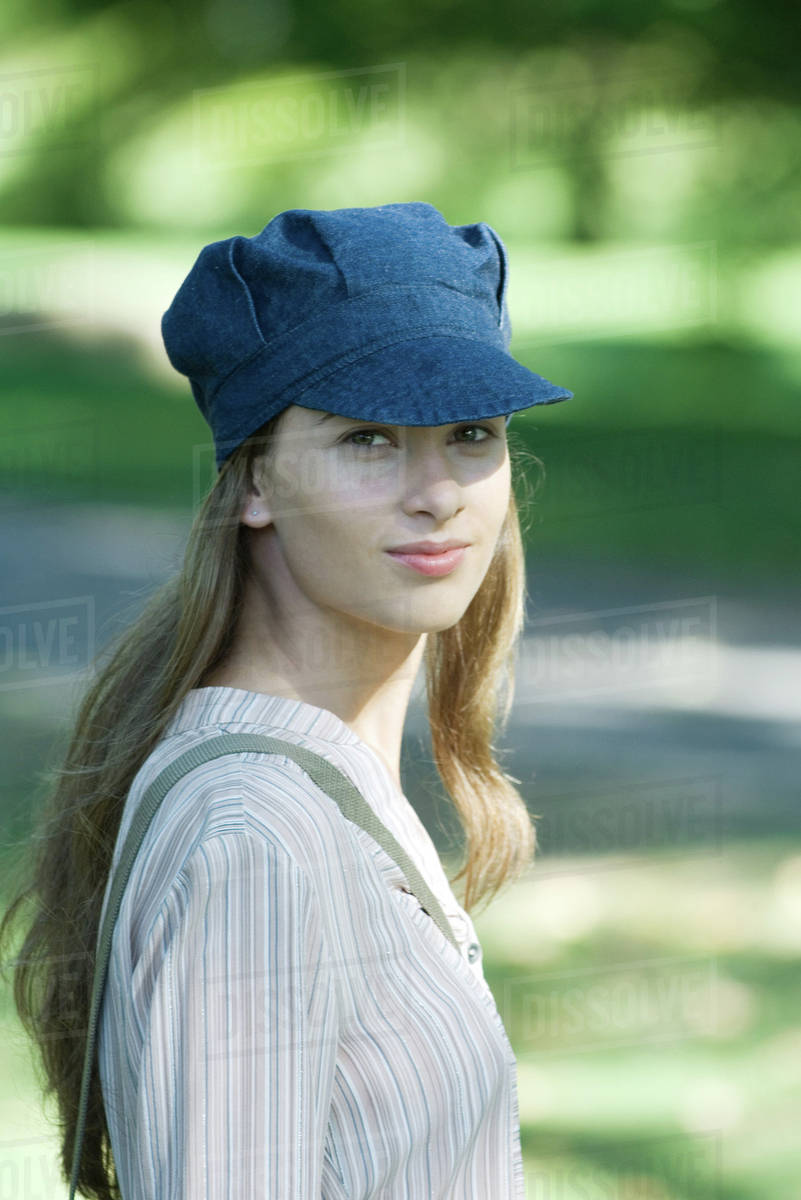 Young woman in park, wearing cap, portrait - Royalty-free Stock Photo ...