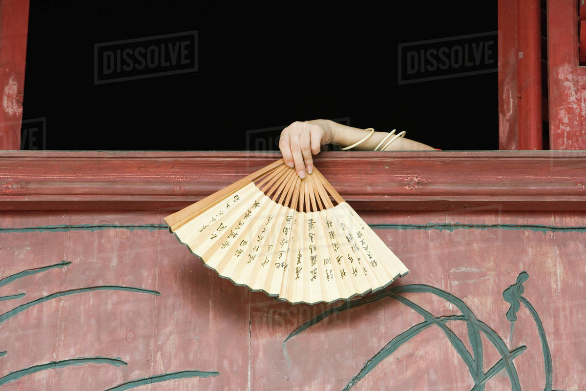 Woman's hand holding fan over edge of windowsill - Royalty-free Stock ...