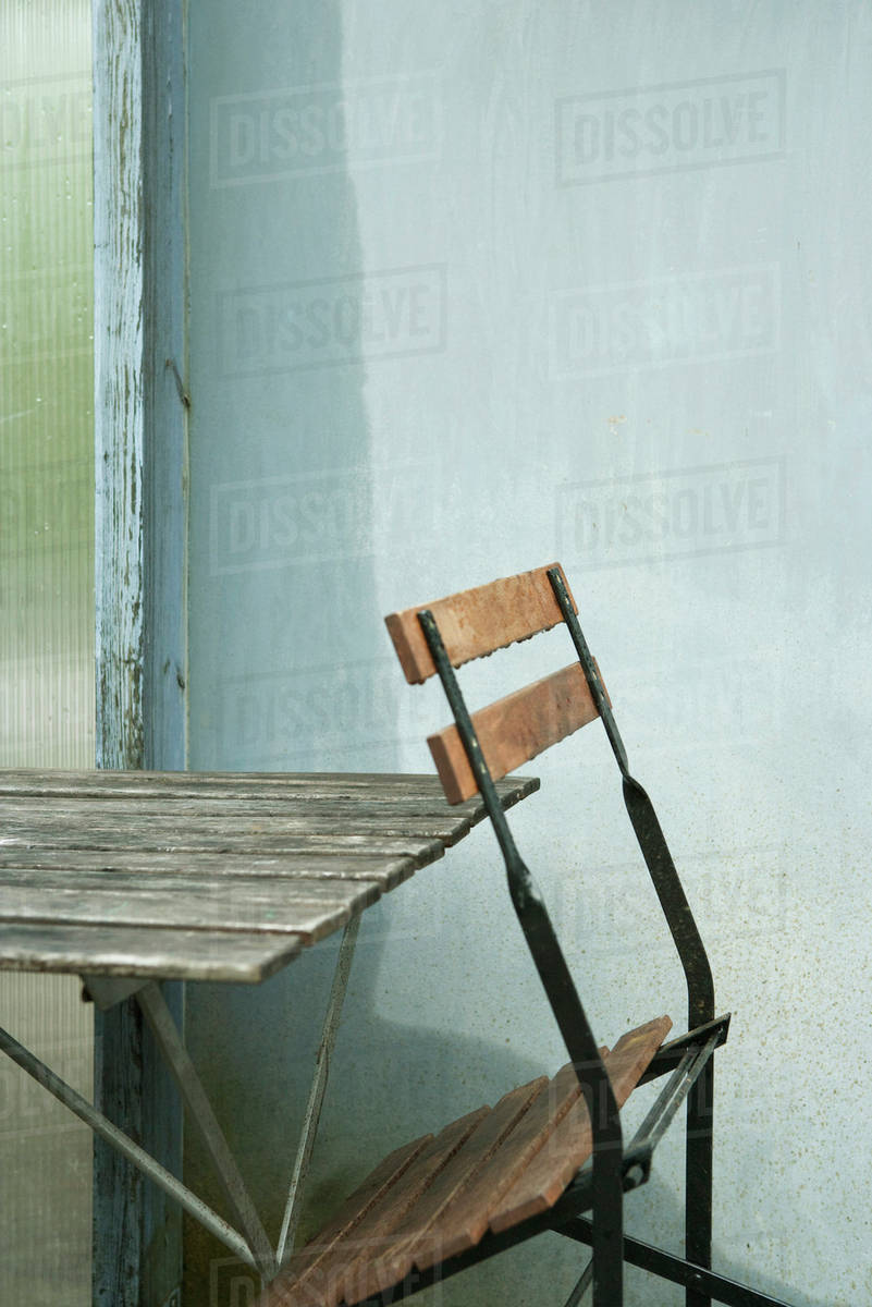 Folding chair leaning against table - Royalty-free Stock Photo | Dissolve